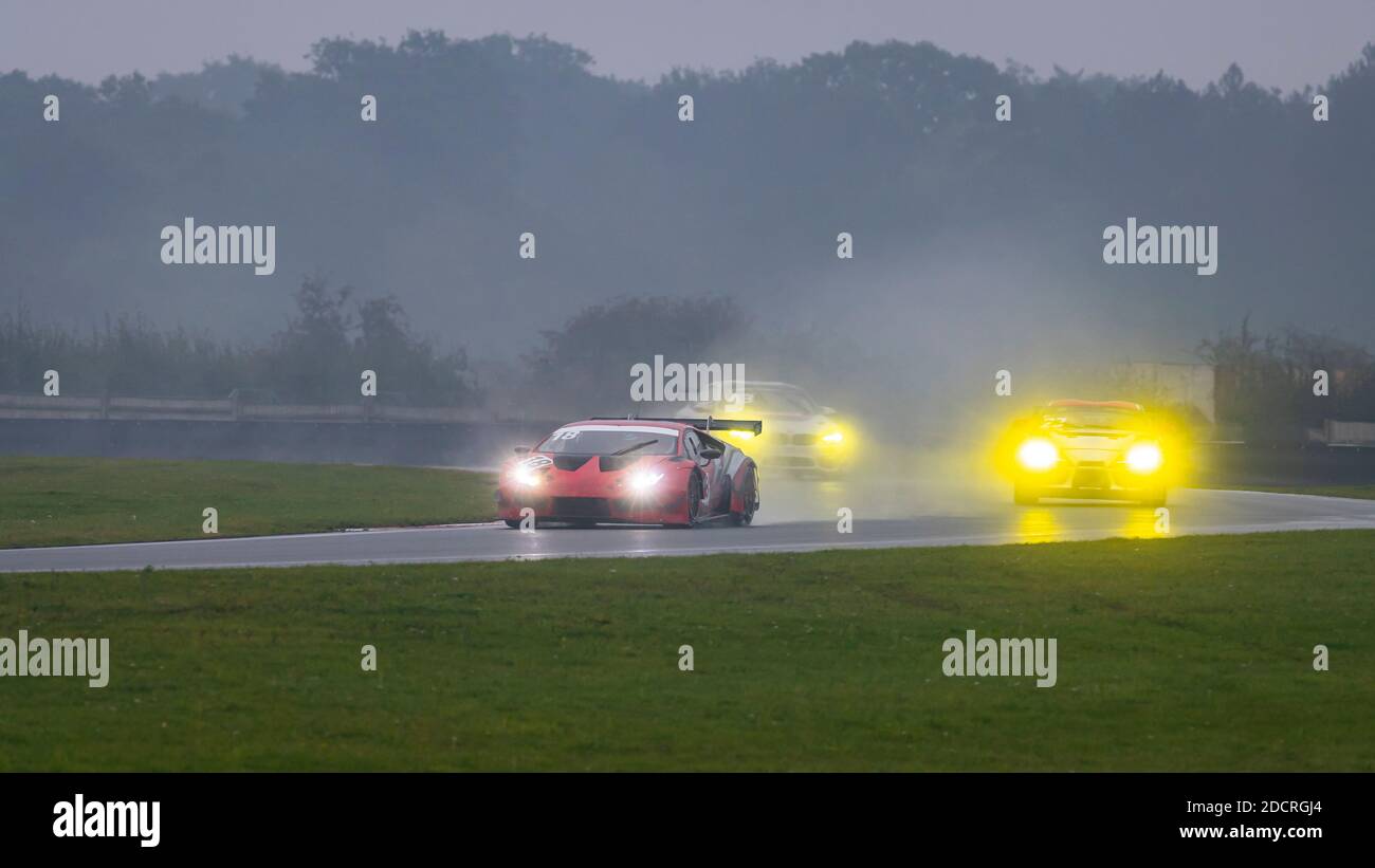A shot of several racing cars as they circuit a track Stock Photo - Alamy
