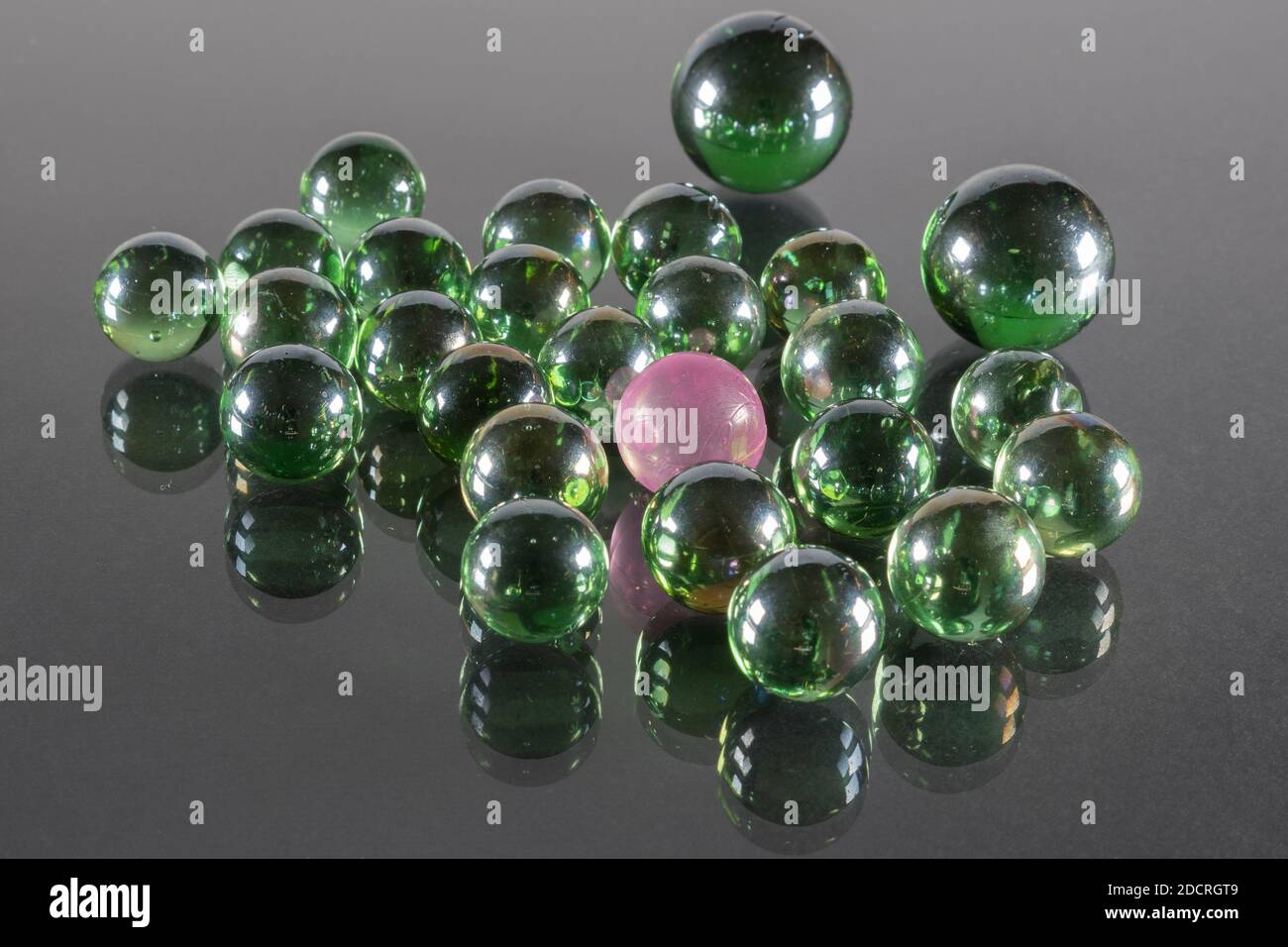 Small Emerald Green Glass Balls with Reflection and One Pink Ball Stock ...
