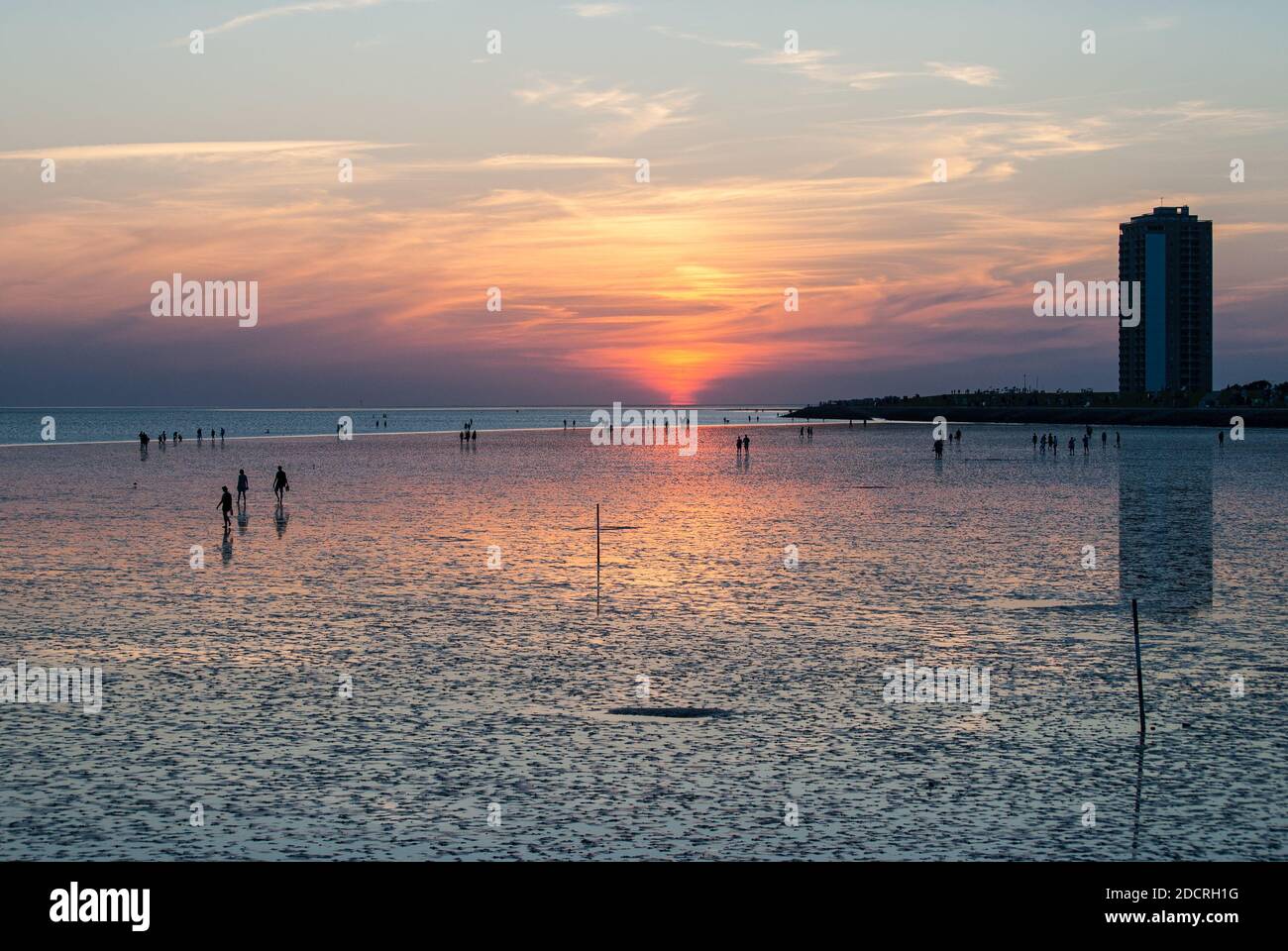 View over the beach and dike of Buesum on a summer evening sunset. An ...