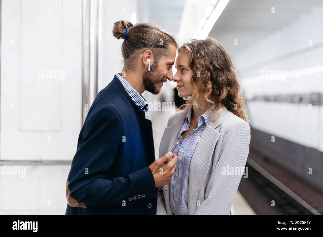 beautiful couple standing on the subway platform Stock Photo - Alamy