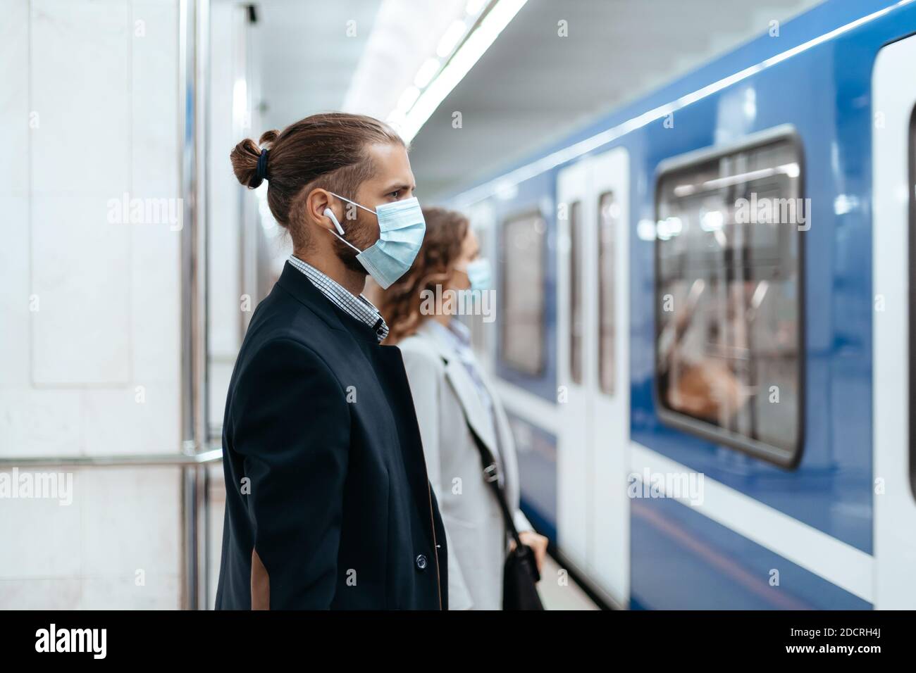 metro passengers standing at a safe distance on the platform Stock ...