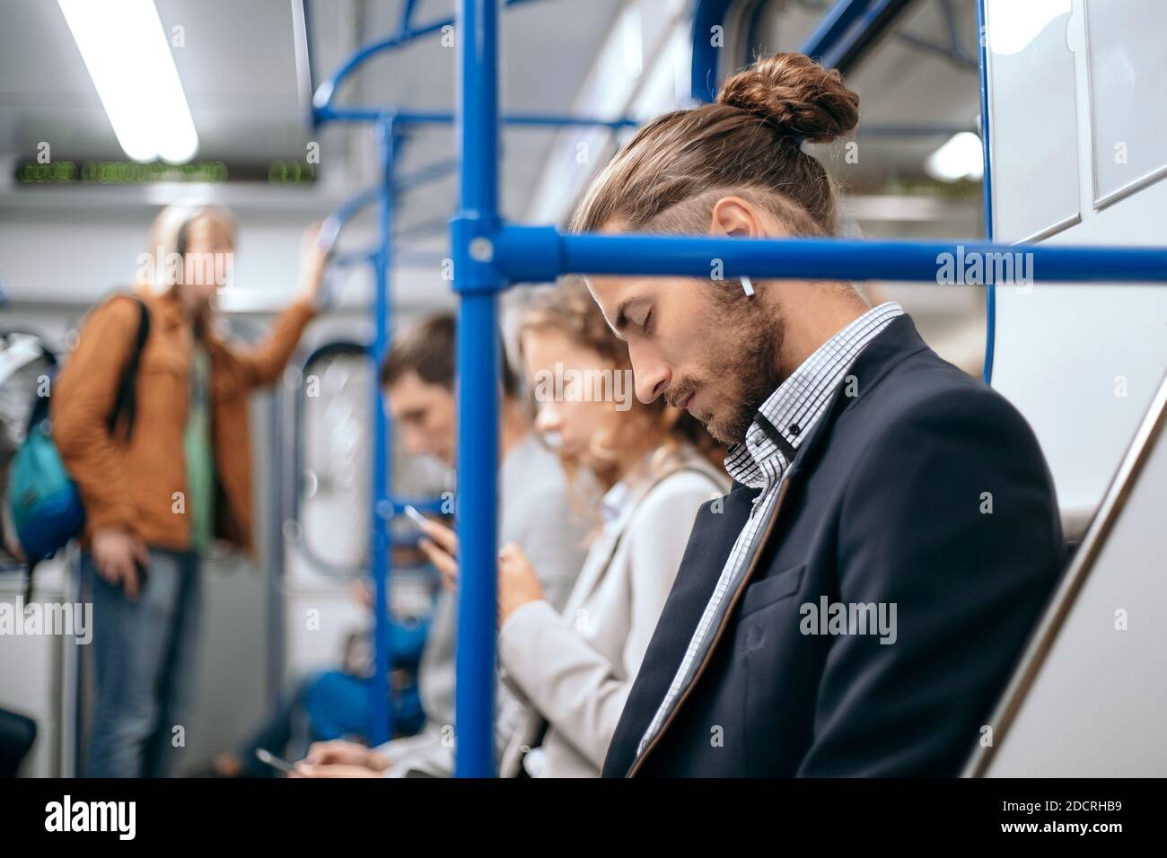 tired business man sleeps in a subway train car Stock Photo - Alamy