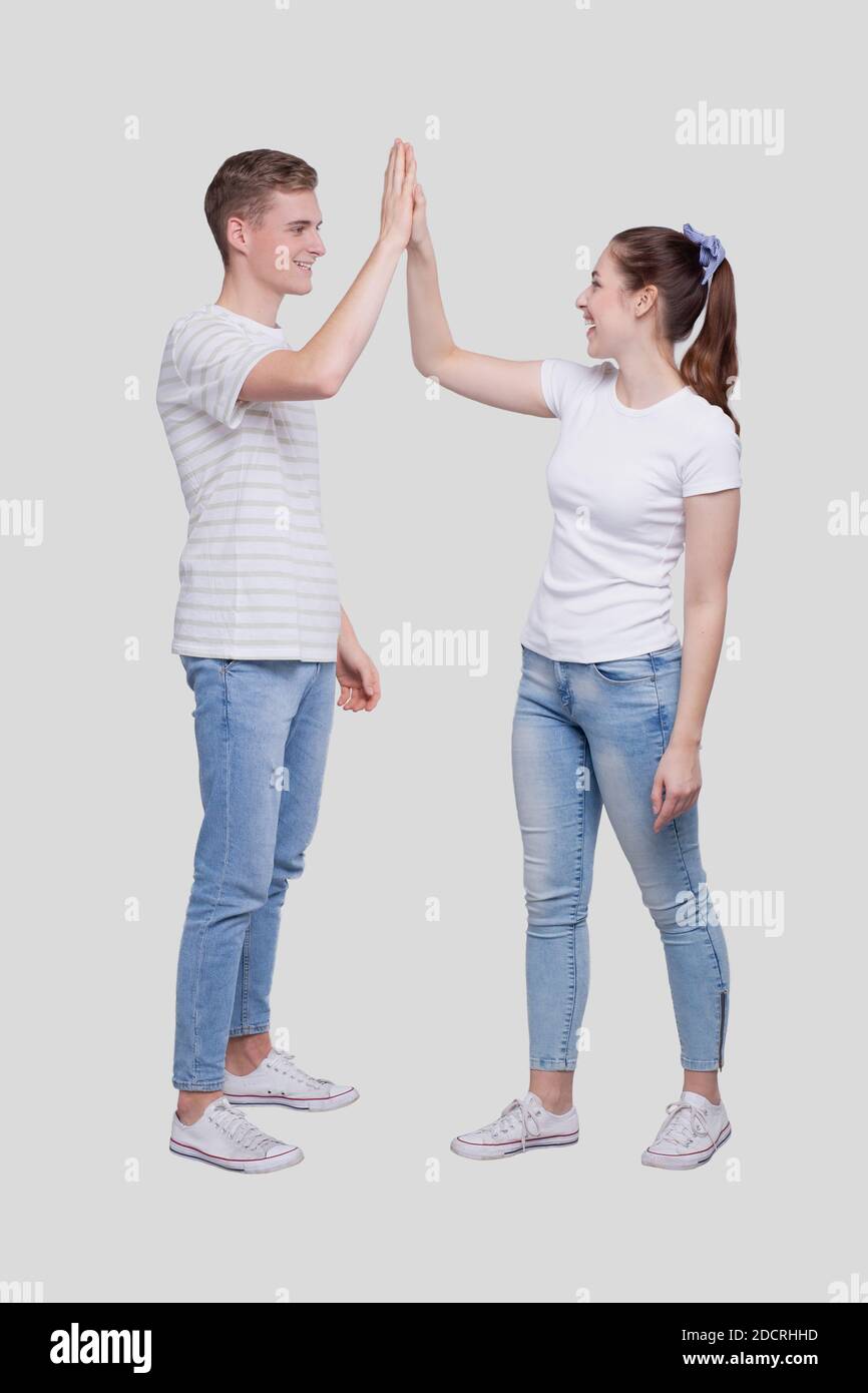 Young Couple Making High Five Standing Isolated Stock Photo - Alamy
