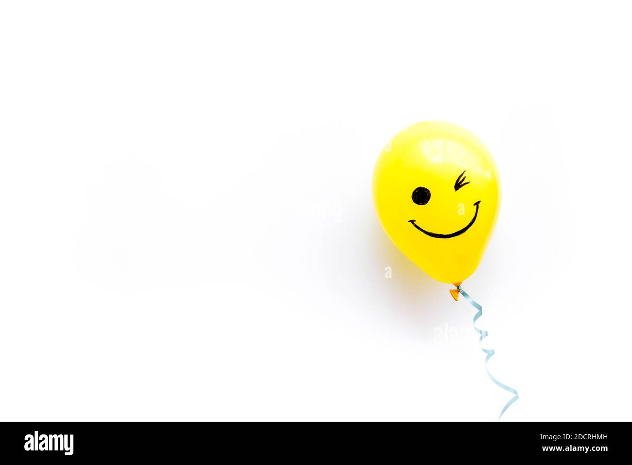 Happiness emotion face on balloon - joy mood background. Top view, copy ...