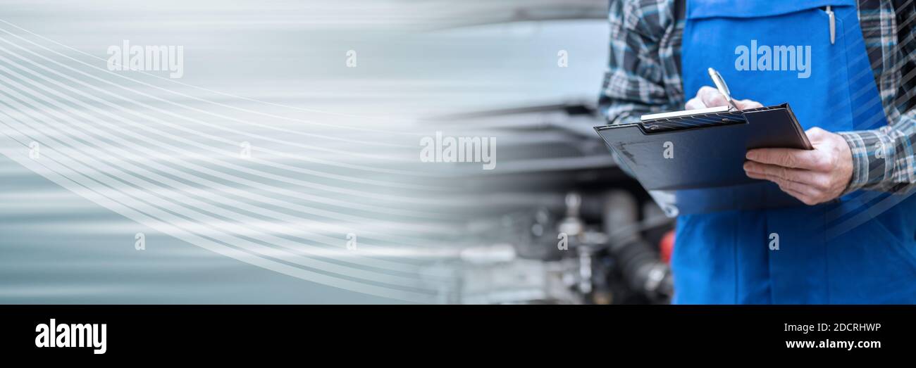 Car mechanic checking a car engine and writing on clipboard; panoramic ...