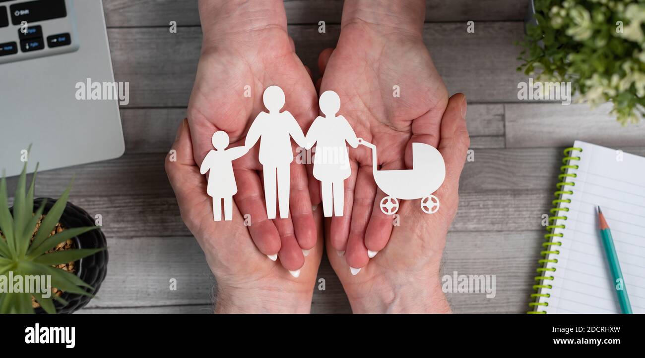 Concept of family insurance with paper family in hands Stock Photo - Alamy