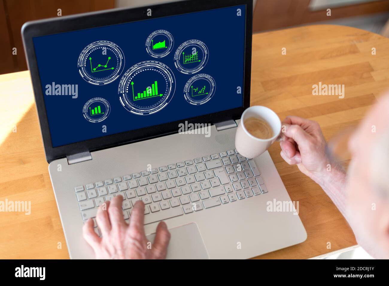 Man using a laptop with graphical analysis concept on the screen Stock ...