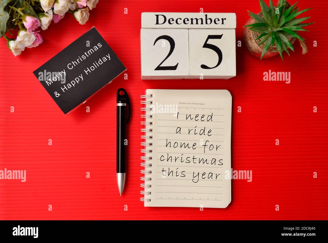 Christmas message written on notepad with with white cube number and ...