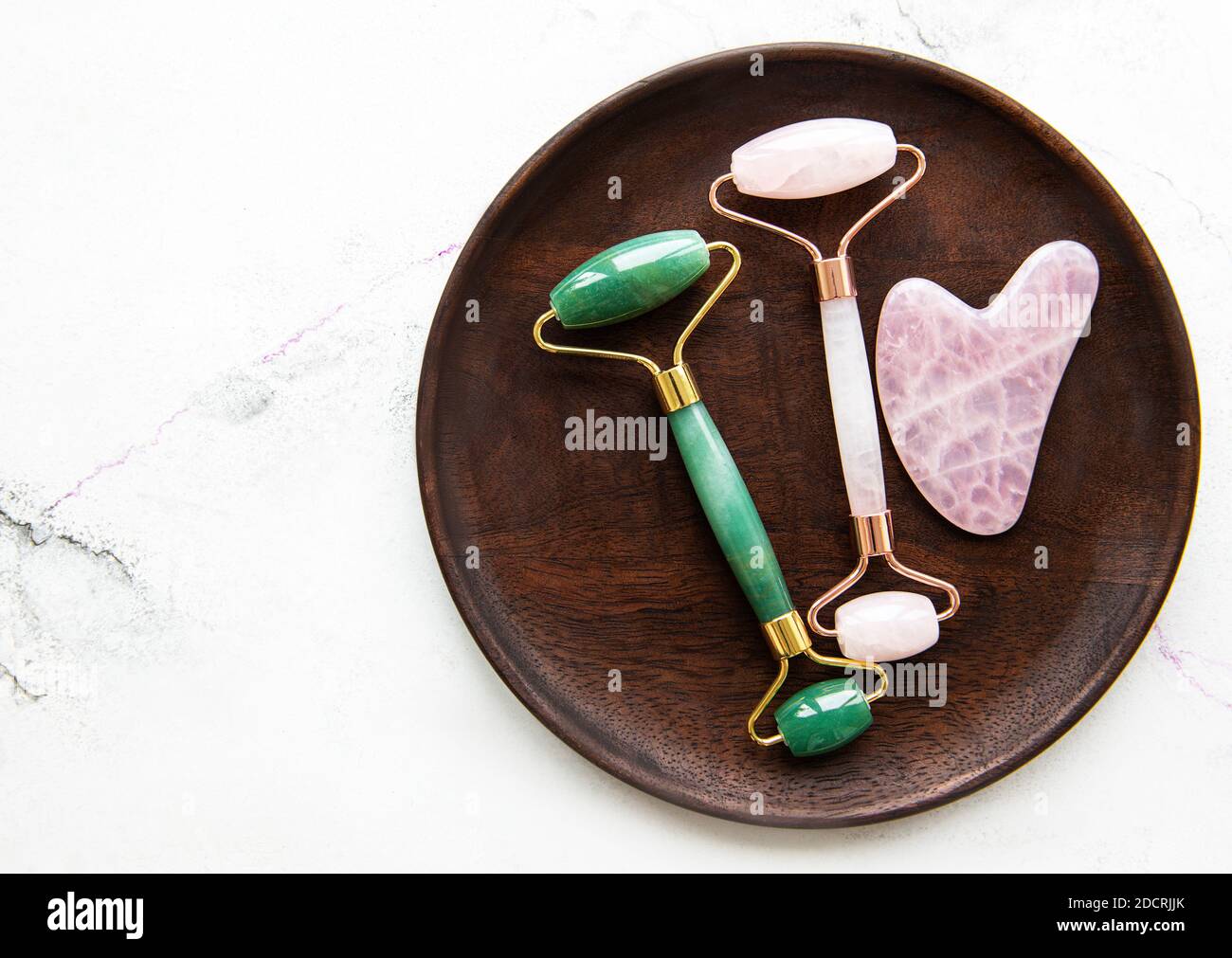 Jade face rollers for beauty facial massage therapy. Flat lay on white ...