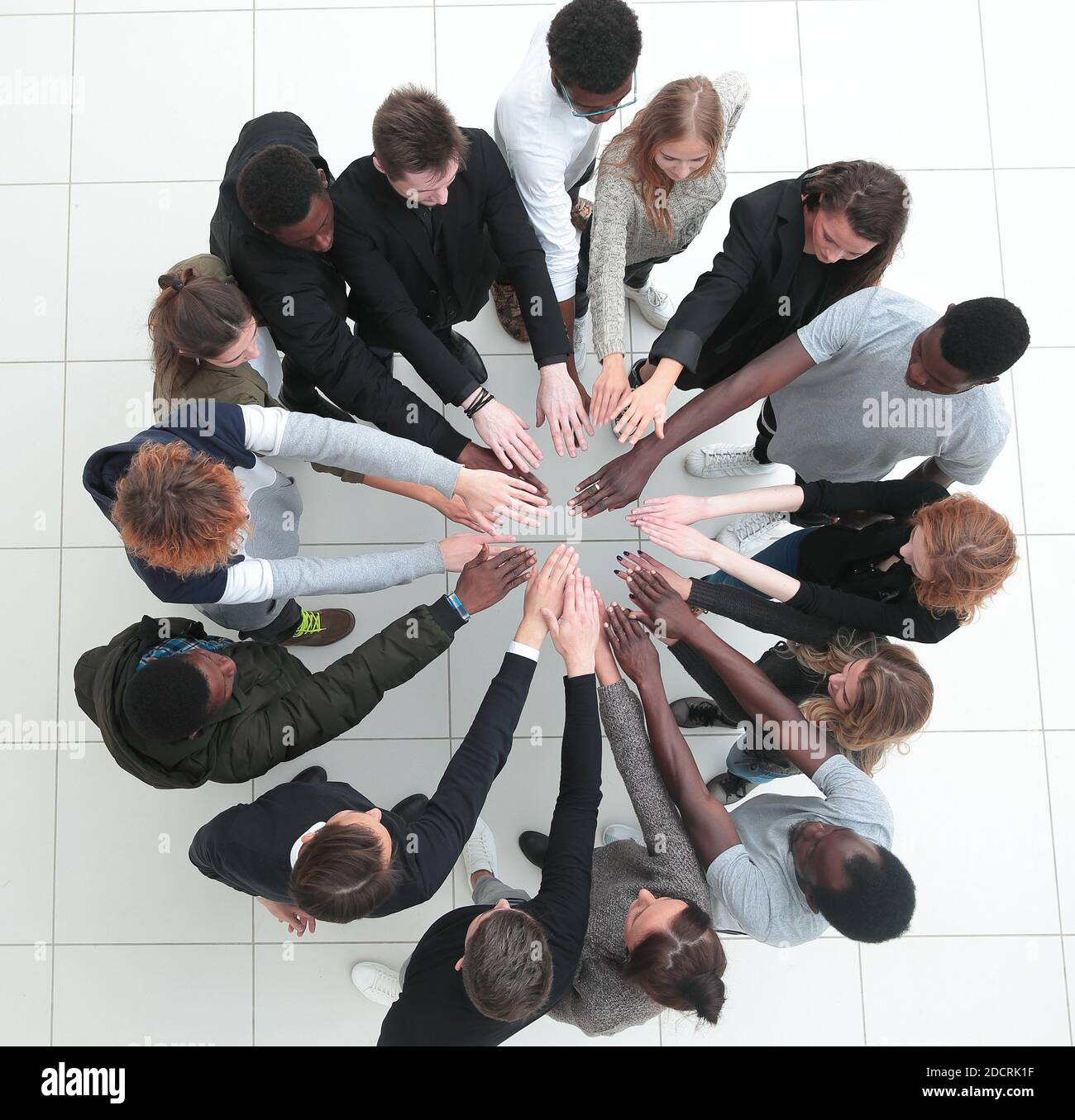 group of young successful people stands around hands together Stock ...