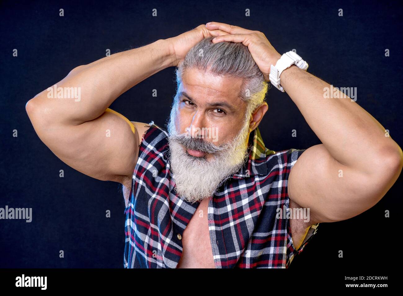 Man with long white beard, muscular arms holding his head. Looking at ...