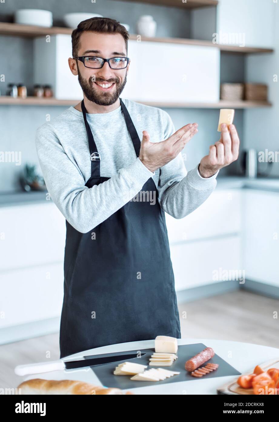 attractive man showing a piece of delicious cheese Stock Photo - Alamy