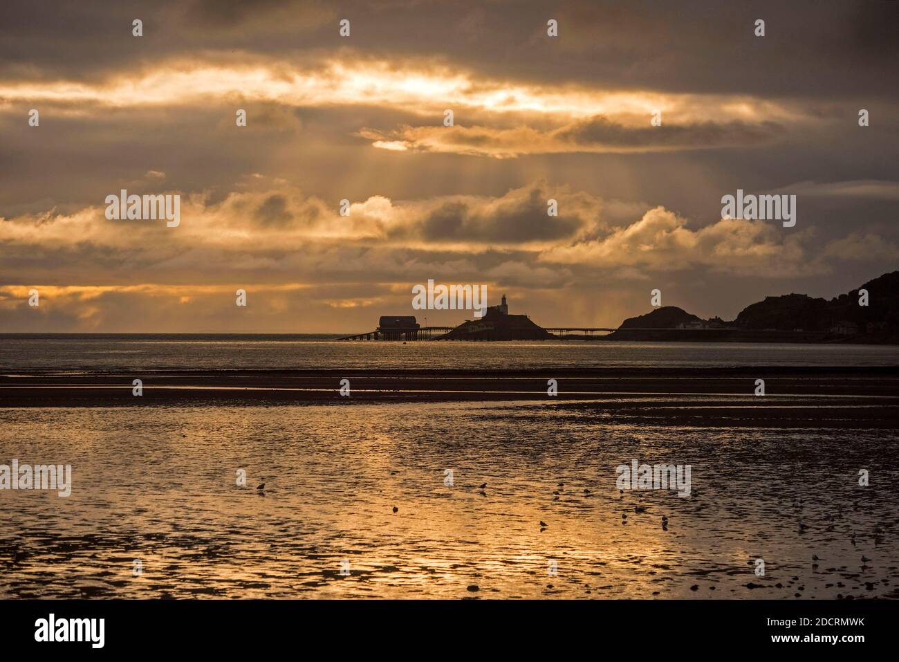 Mumbles, Swansea, UK. 23rd Nov, 2020. The sun peeks through the clouds ...