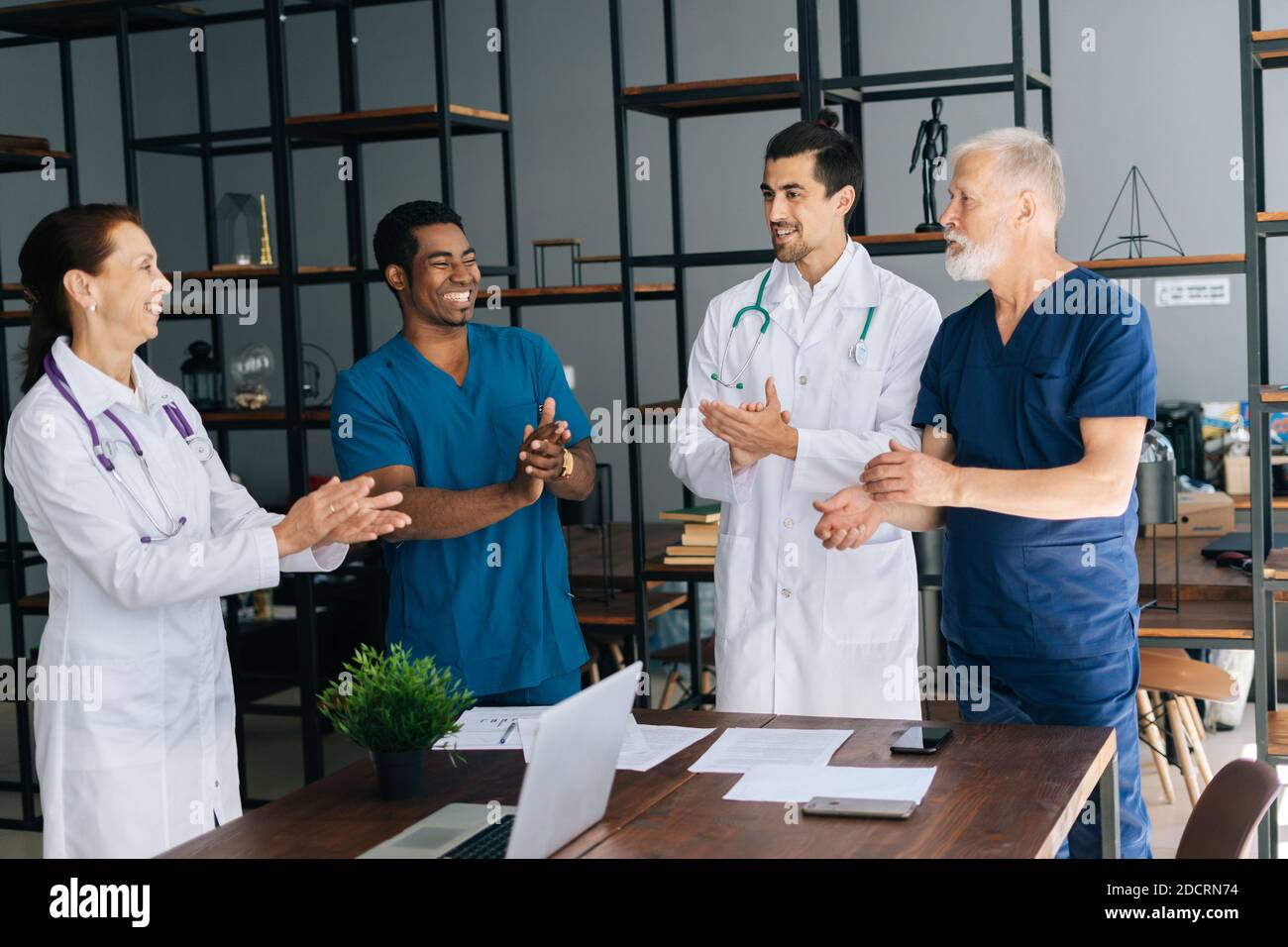 Successful happy gray-haired mature male chief doctor leader get team ...