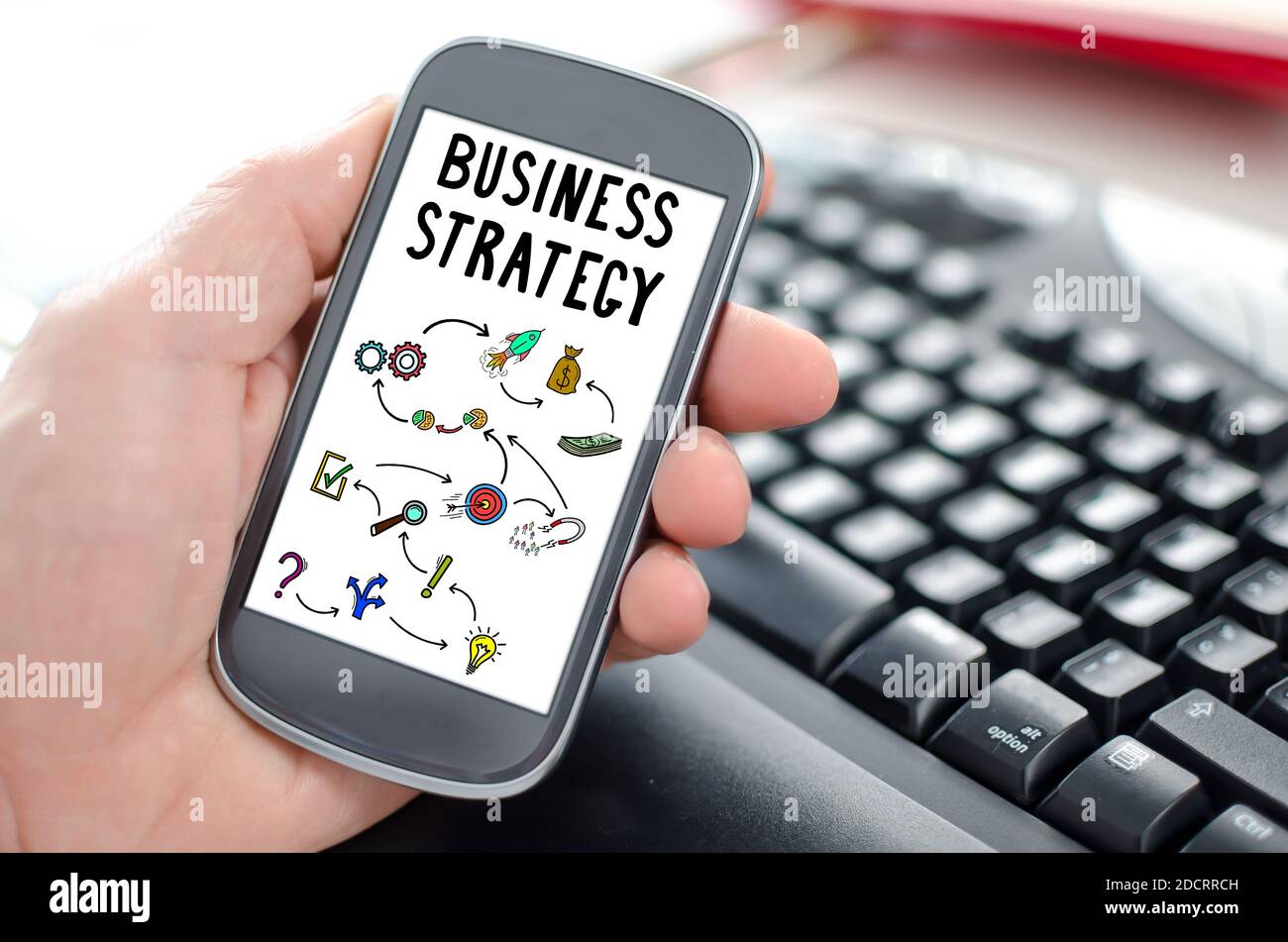 Hand holding a smartphone showing a business strategy concept Stock ...