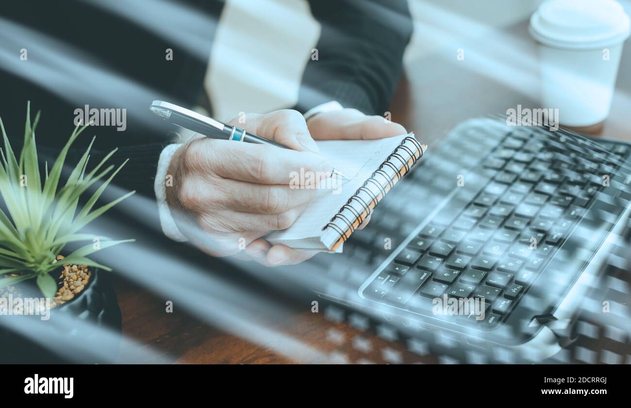 Male hands taking notes on notebook; light effect Stock Photo - Alamy