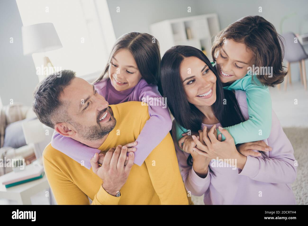Photo of big family four members parents hold piggy back children look ...