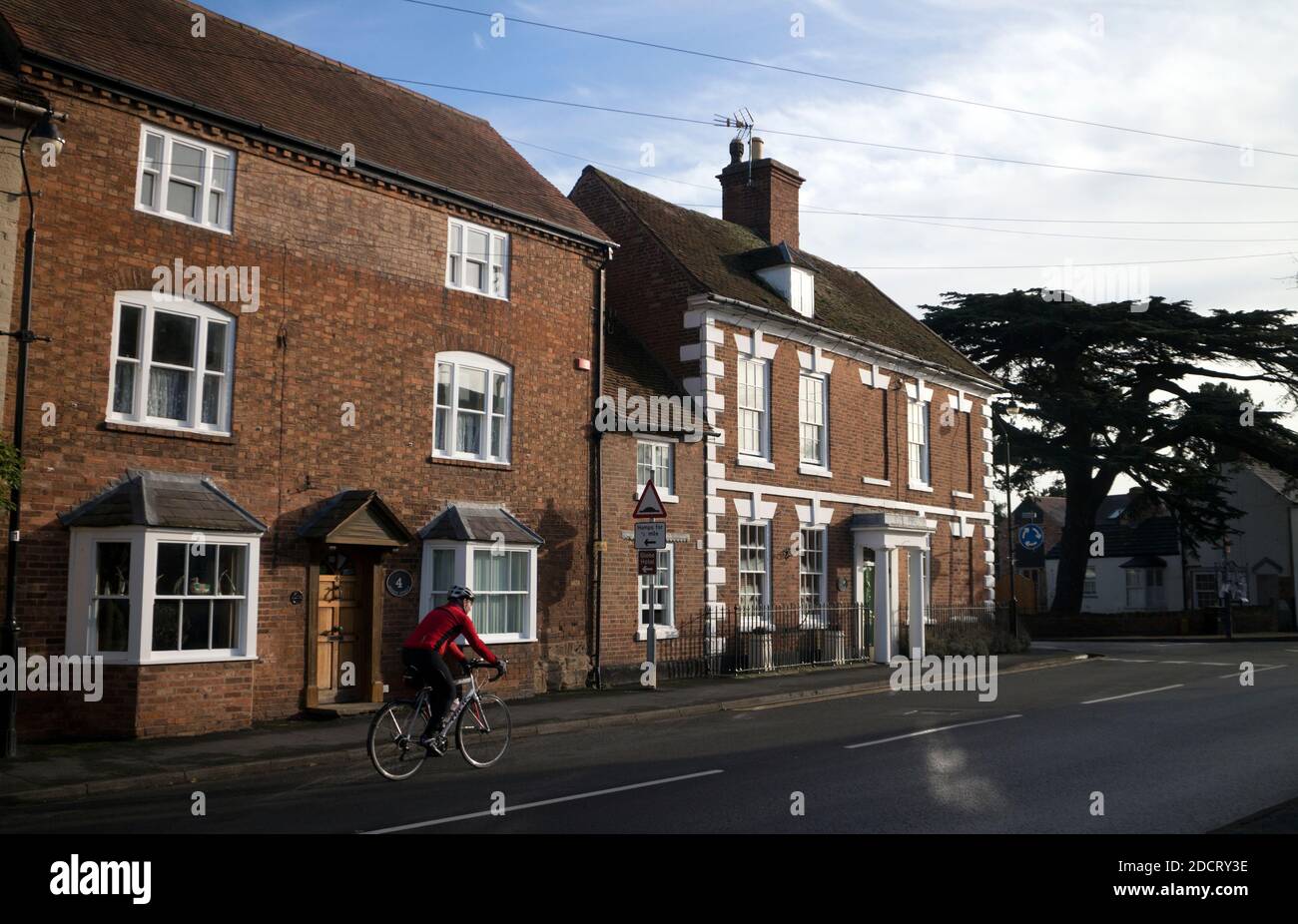 A person cycling through Barford village, Warwickshire, England, UK ...