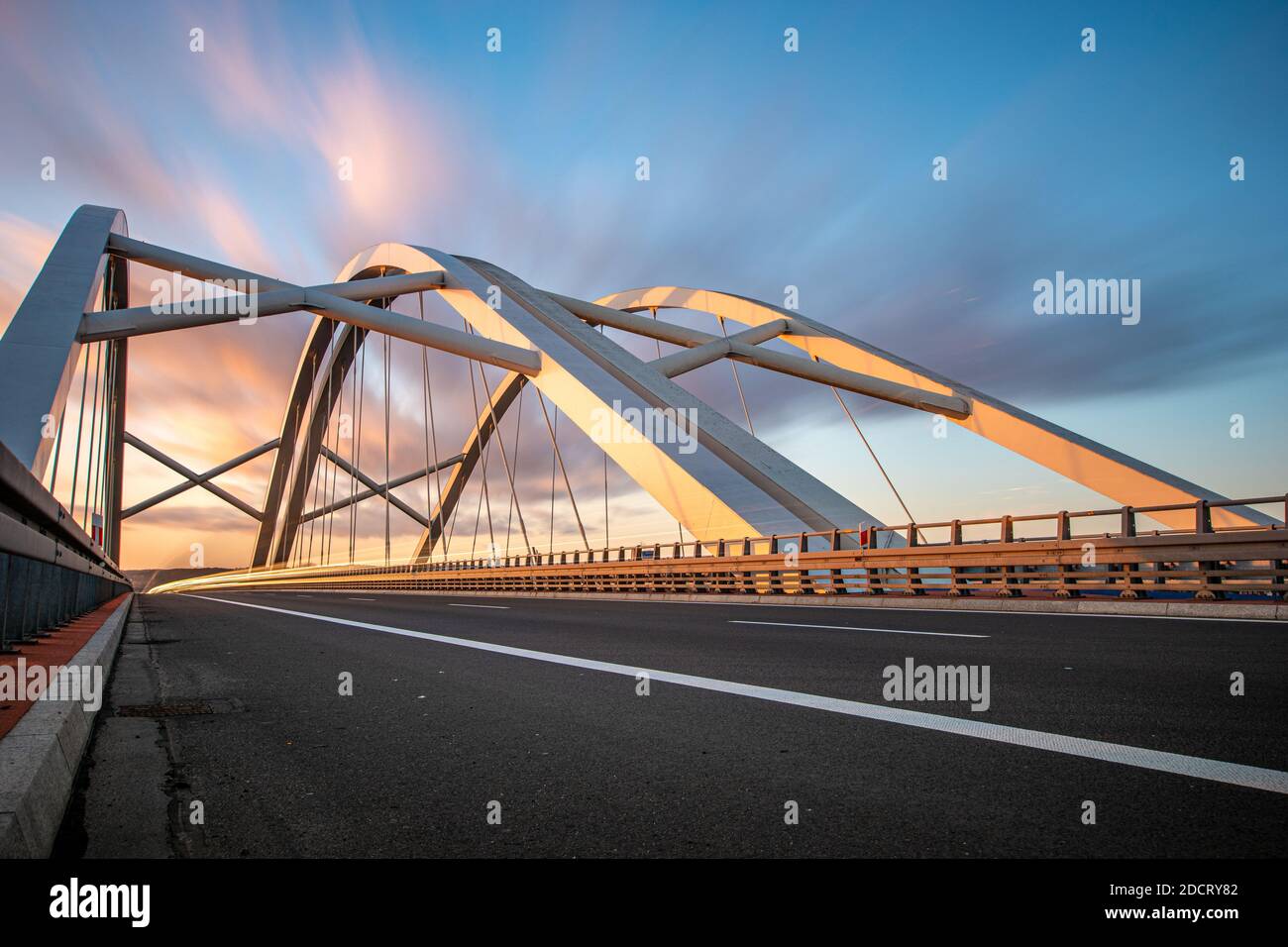 Modern construction highway bridge at sunset Stock Photo - Alamy