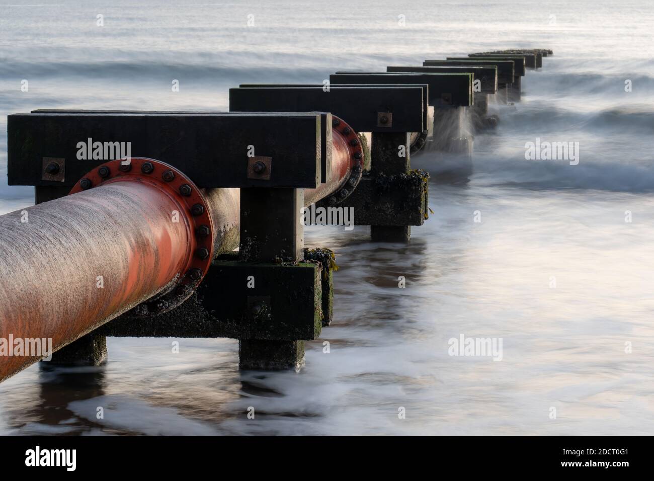 Pipe in the sea on a calm tide Stock Photo - Alamy