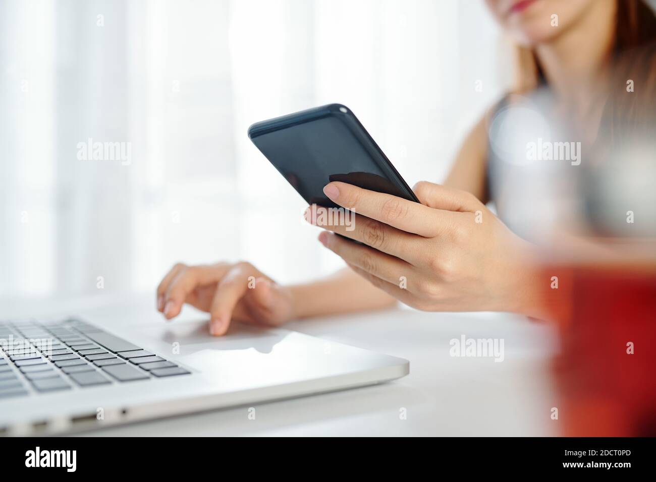 Female entrepreneur checking notifications Stock Photo - Alamy