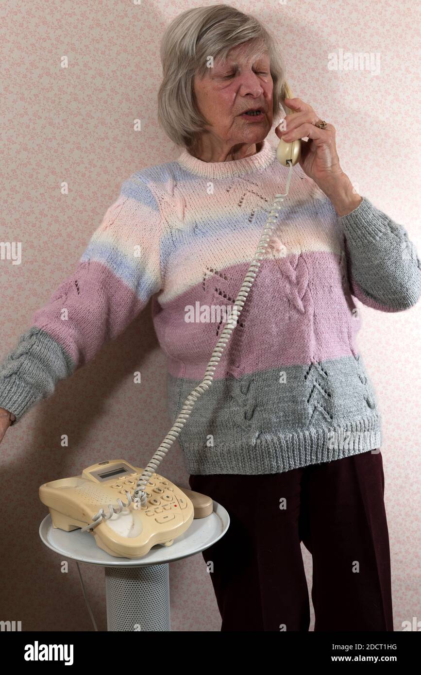 Old lady on telephone landline hi-res stock photography and images - Alamy