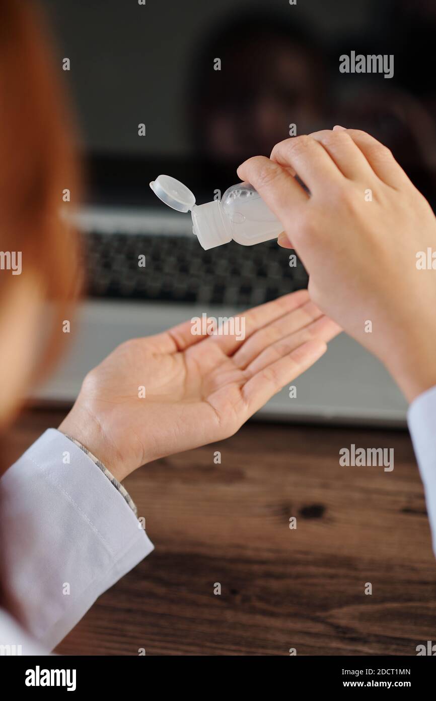 Laboratory worker disinfecting hands Stock Photo - Alamy