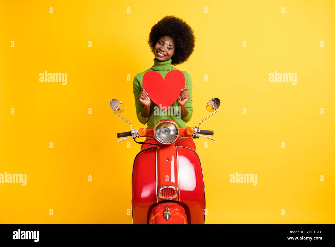 Photo portrait of black skinned girl on motorcycle holding big red ...