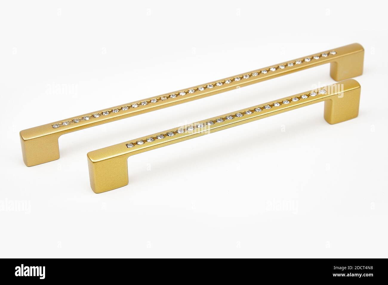 Gold metallic door handle with shiny transparent stones on white ...