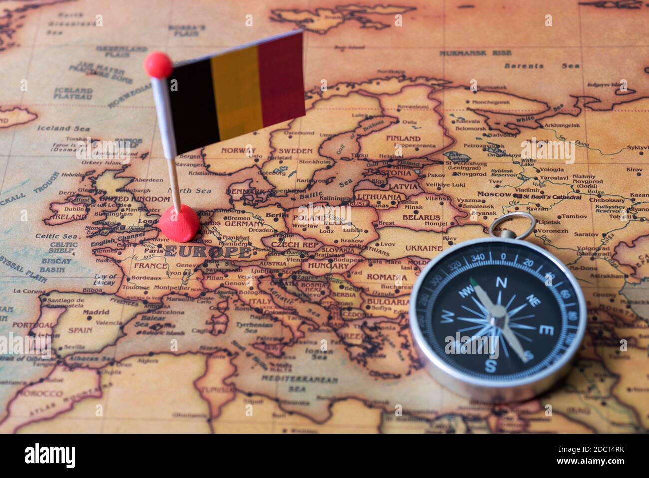 Flag of Belgium and compass on the world map. The concept of travel and ...