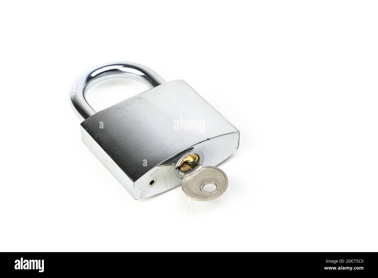 closeup on hardened steel padlock with hand and key on white background ...