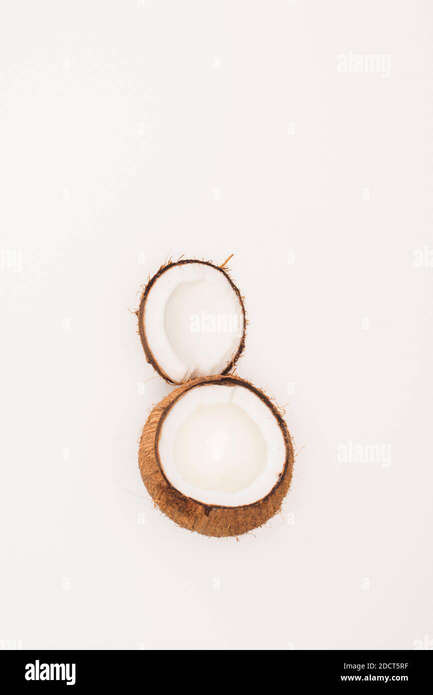 top view of coconut halves on white surface with copy space Stock Photo ...