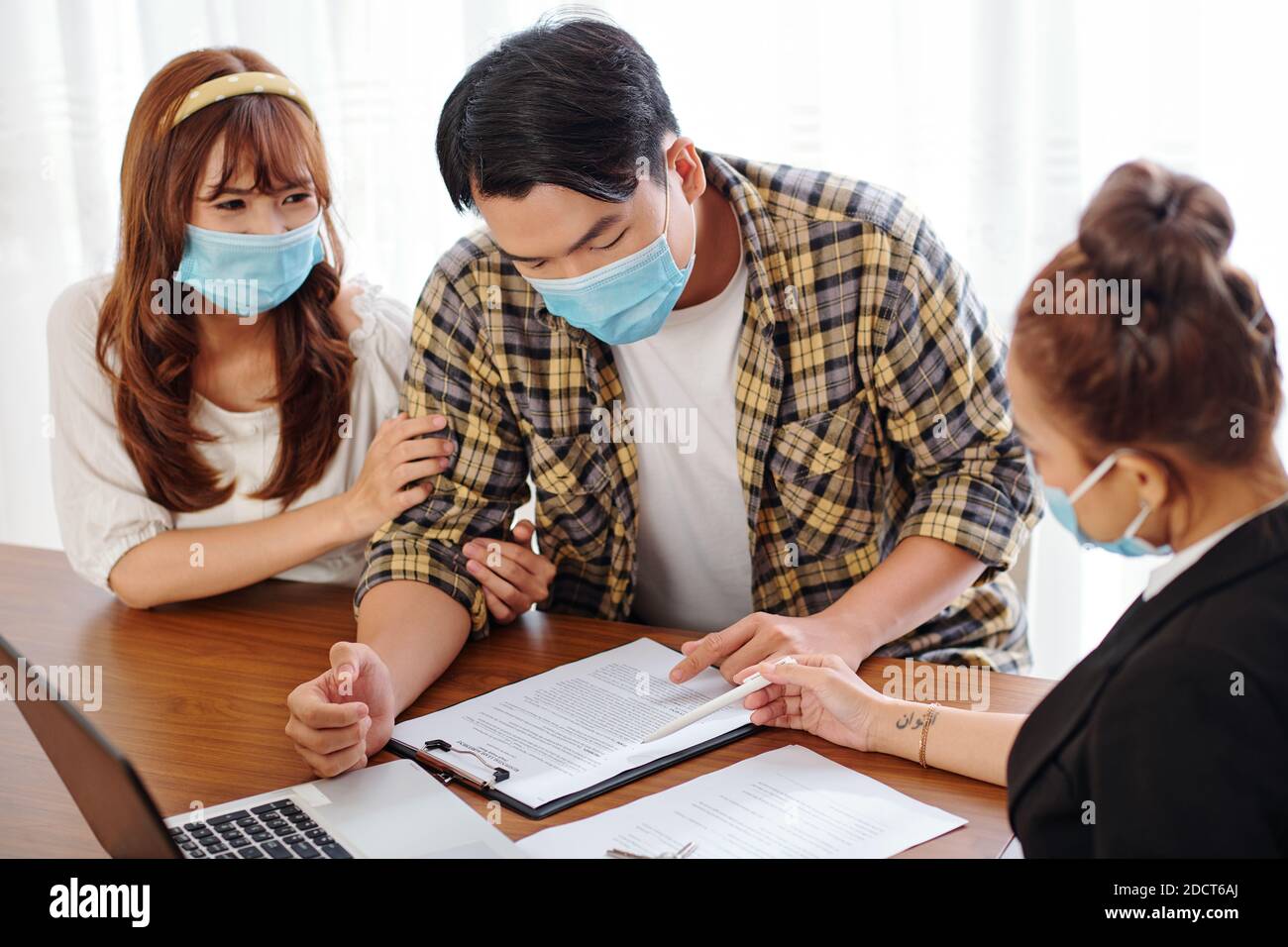 Couple reading rental lease agreement Stock Photo - Alamy