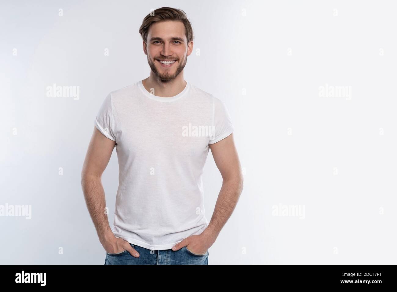Portrait of a smart young man standing against white background Stock ...