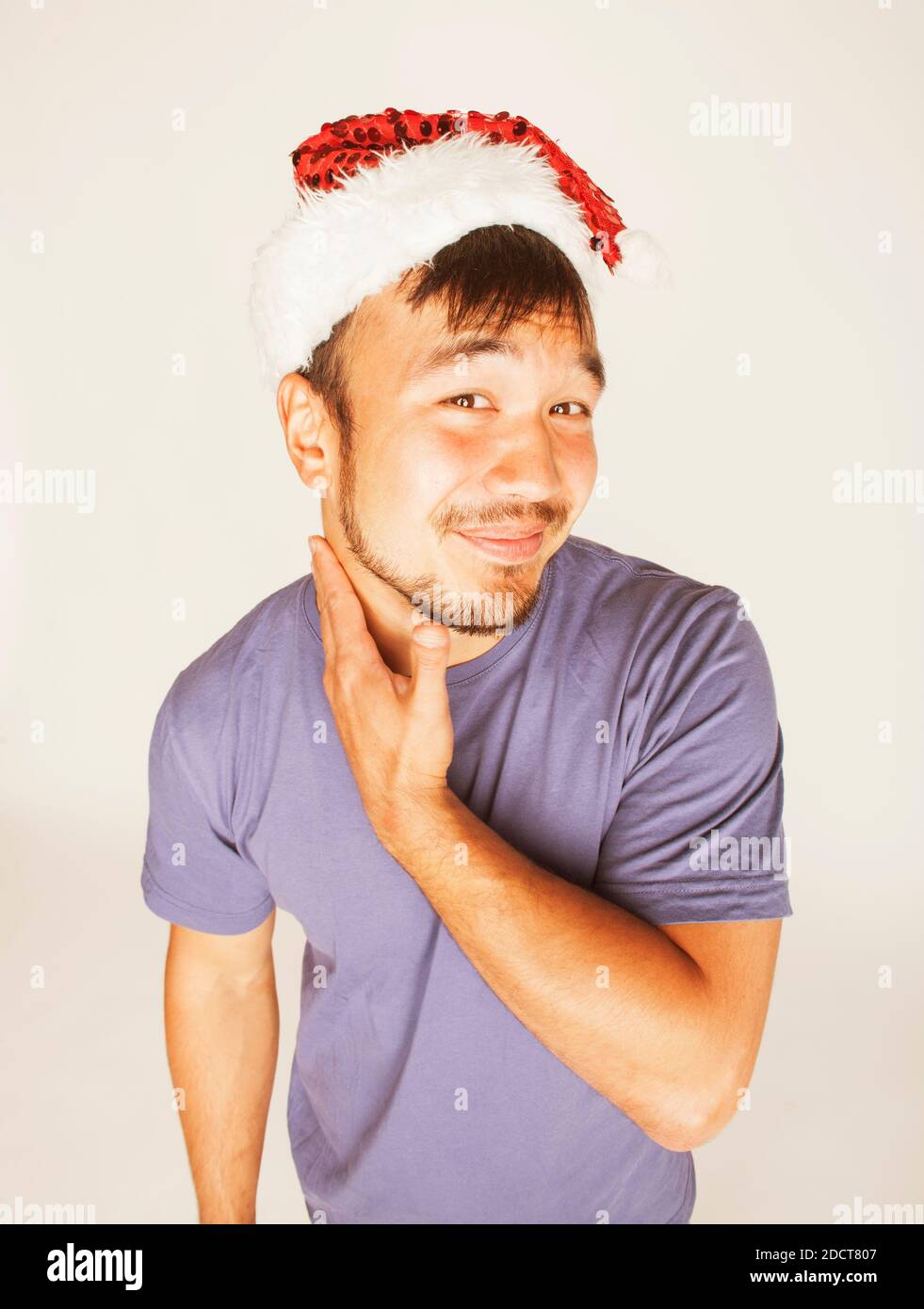 funy exotical asian Santa claus in new years red hat smiling Stock ...