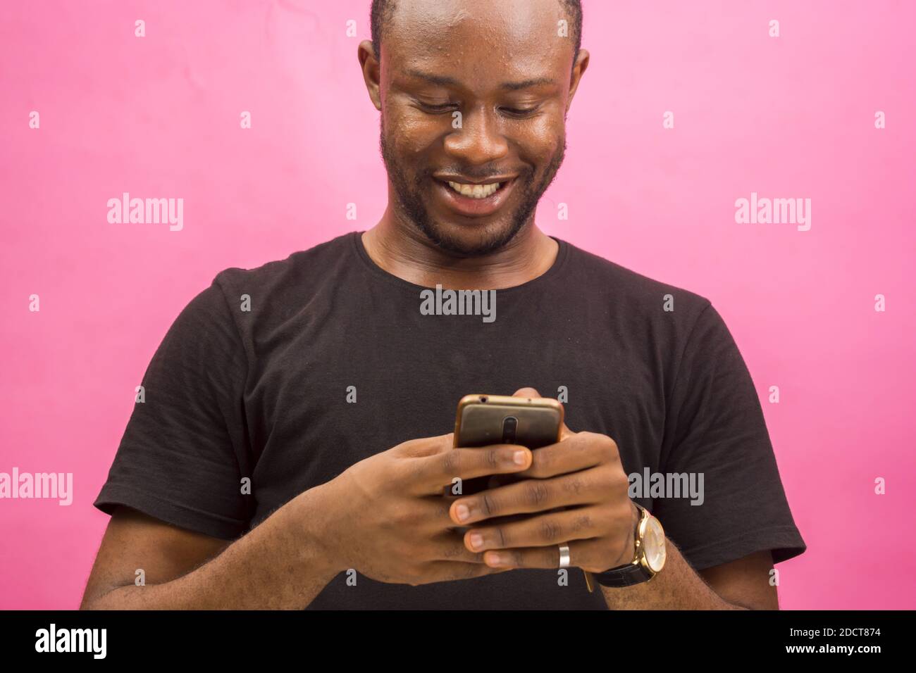 A closeup shot of a young African man using his smartphone Stock Photo ...