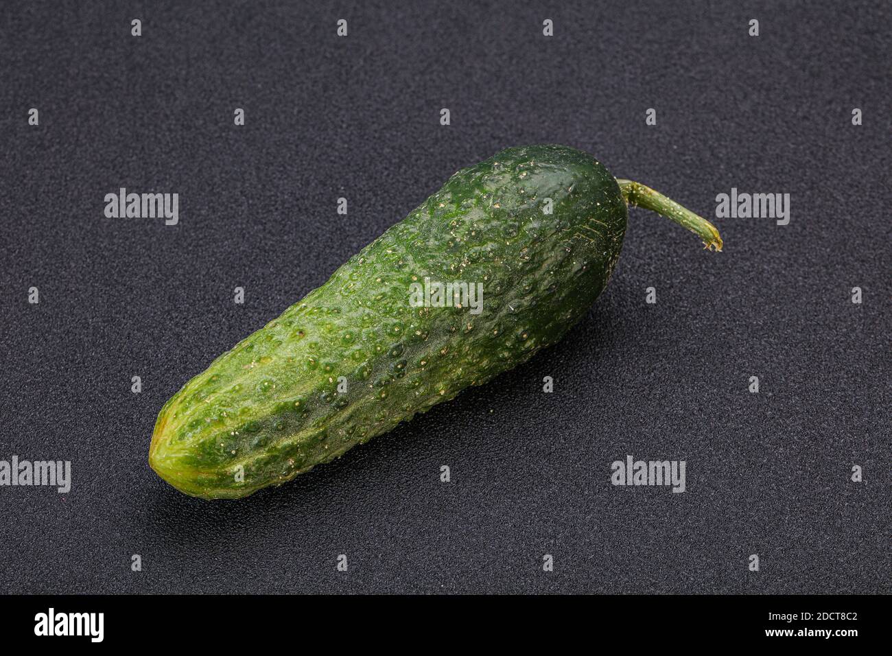 Green ripe fresh one cucumber over background Stock Photo - Alamy