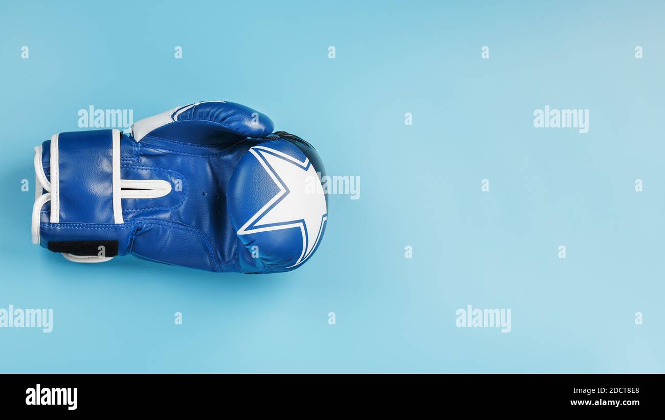 Blue Boxing glove on a blue background, free space. The concept of ...