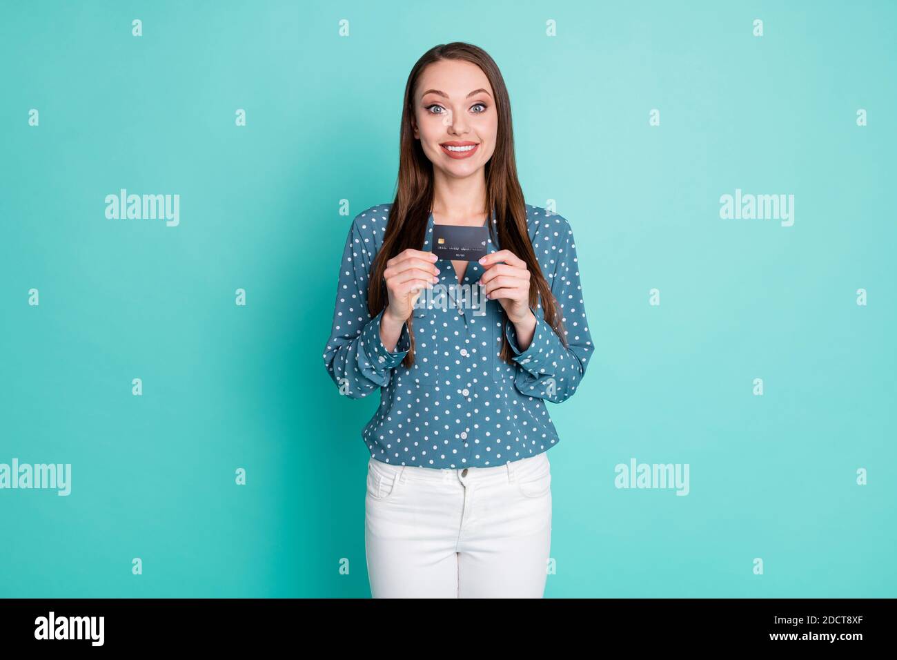 Photo of positive girl hold credit card wear blue polka-dot white ...