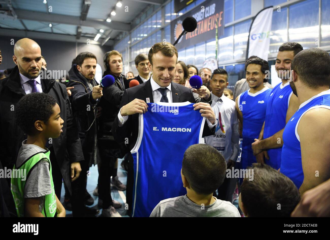 French President Emmanuel Macron watches children practise basketball ...