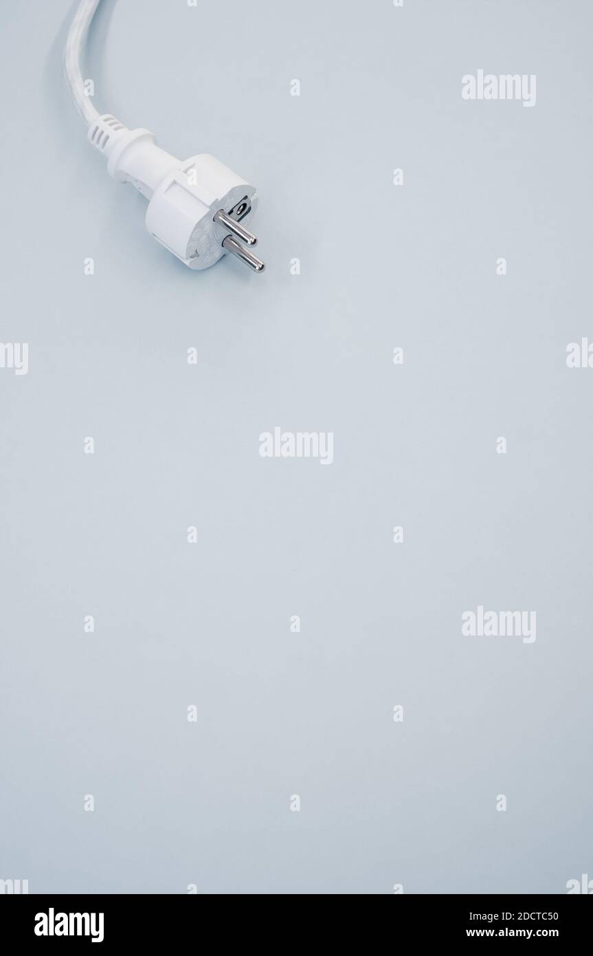 A vertical shot of an electrical plug and wire on a white surface Stock ...