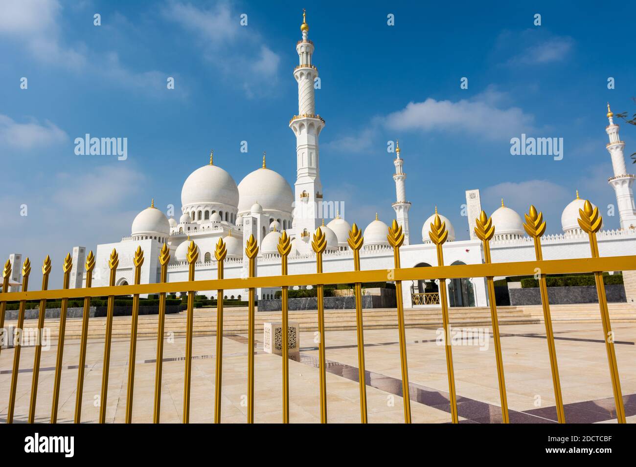 Golden fence and blurred background of the white Grand Mosque built ...