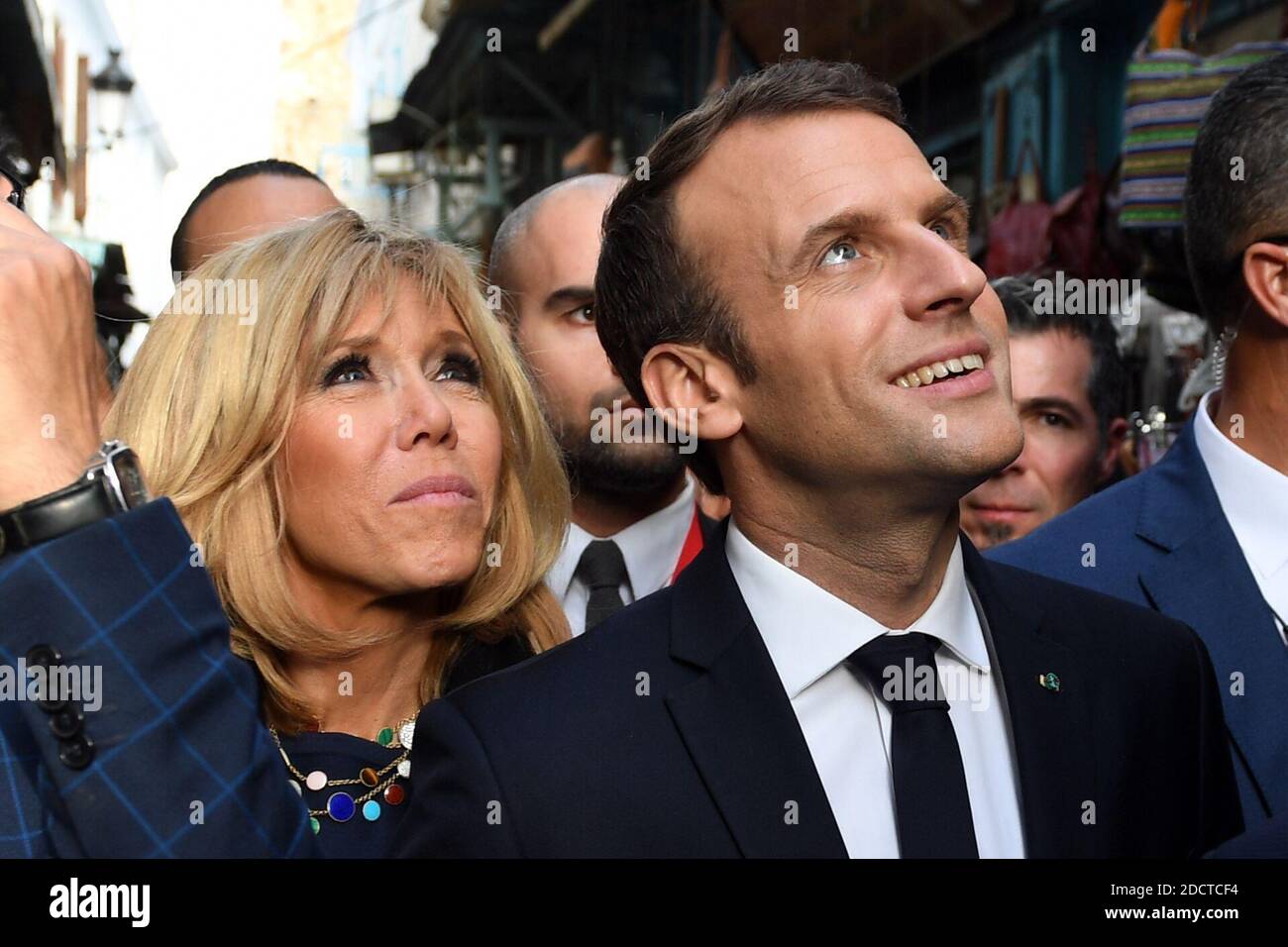 French President Emmanuel Macron (R) and his wife Brigitte (L) look up ...
