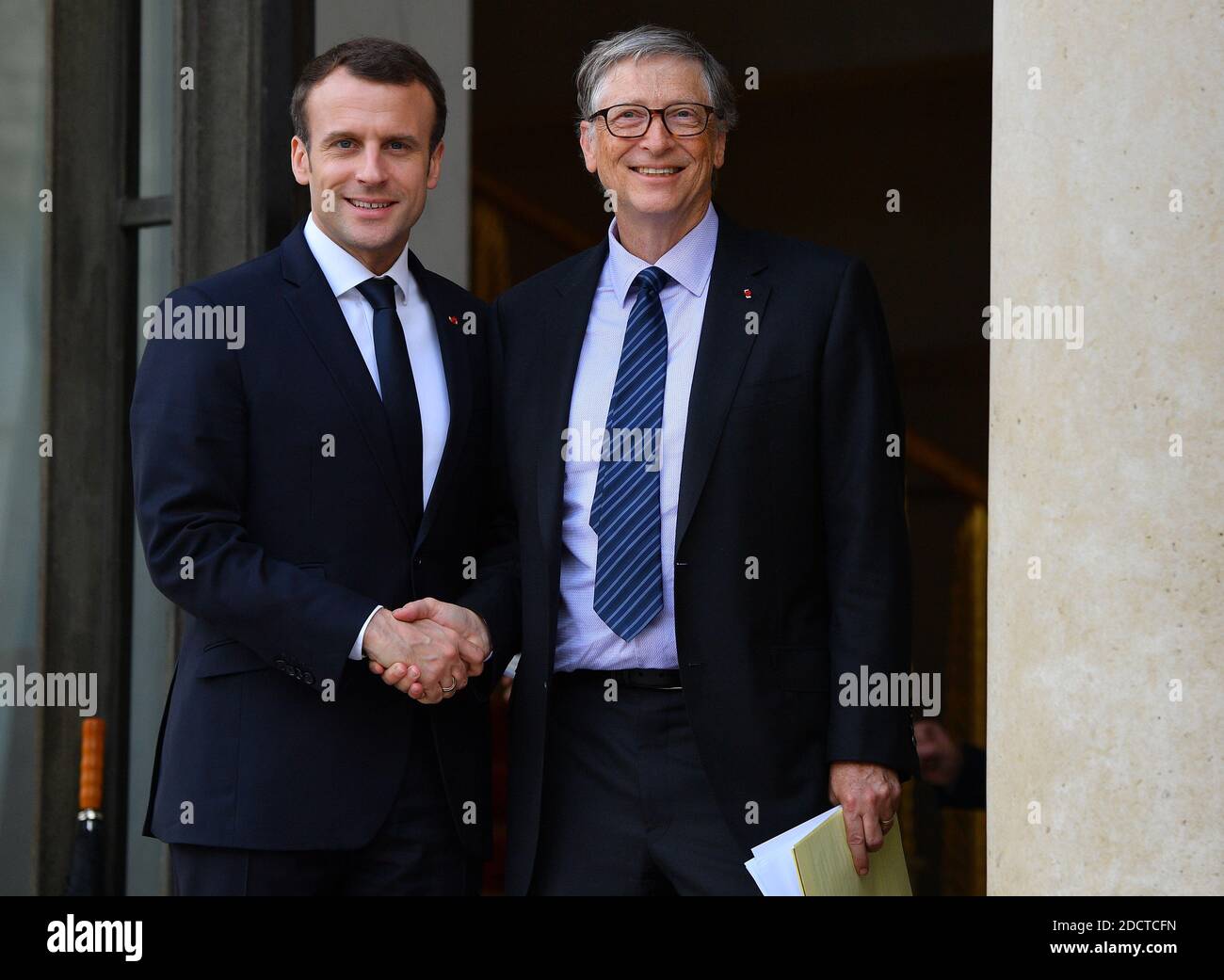 French President Emmanuel Macron (L) accompanies Microsoft founder and ...