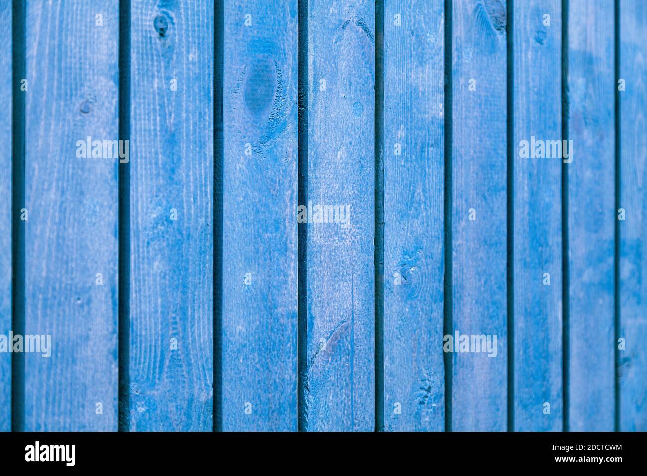 Background image - a light blue wooden fence extending into the ...