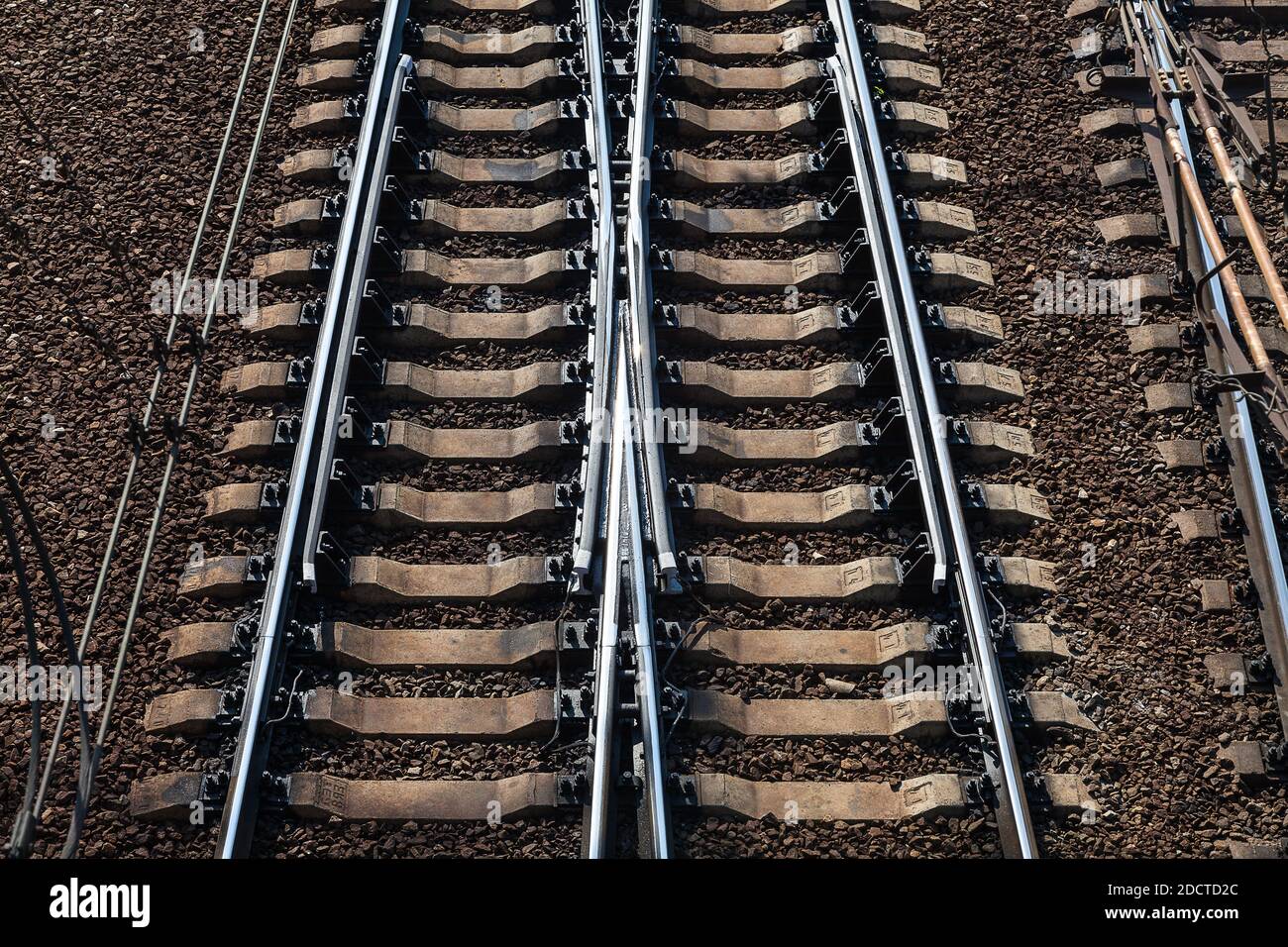 Railroad arrow with rails shining in the sun Stock Photo - Alamy