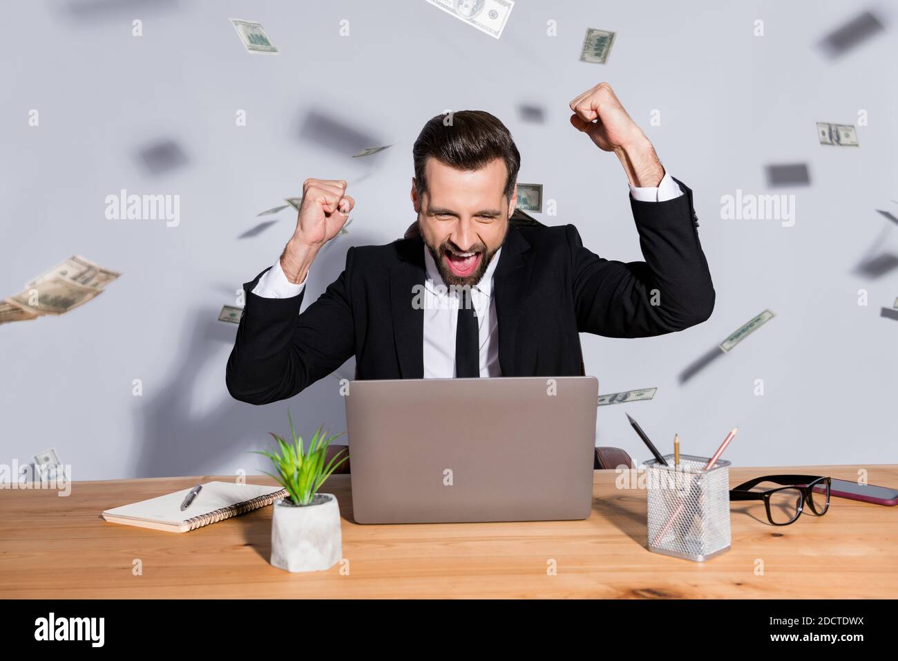 Photo of handsome crazy business guy notebook table usa bucks fall rich ...