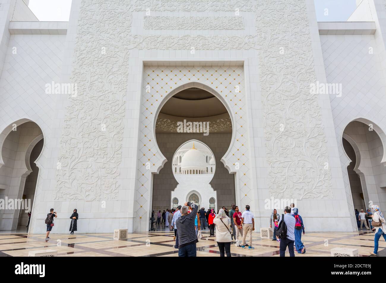 Lots of tourists visiting the Grand Mosque built with marble stone ...