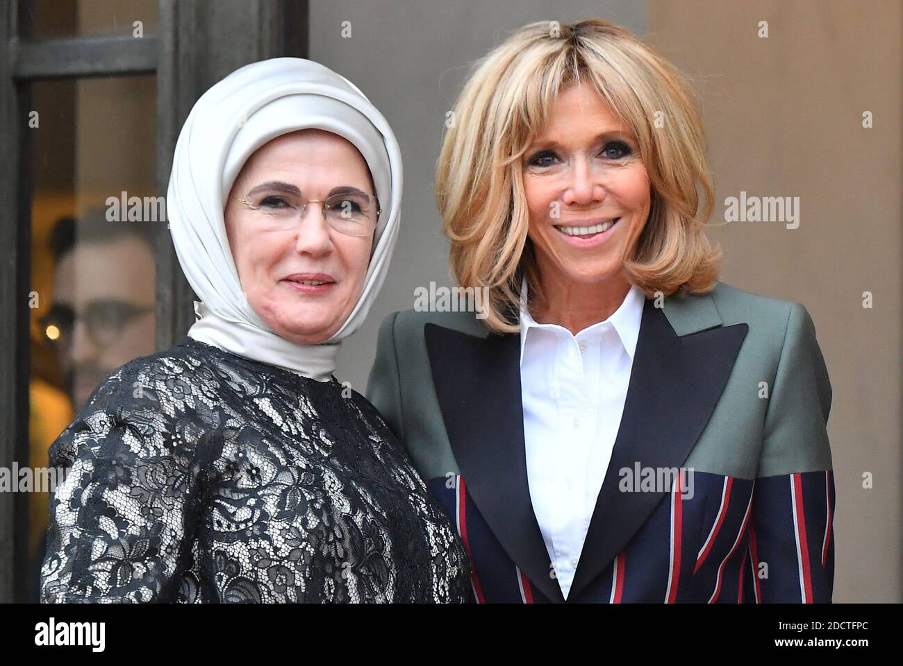 Ermine Erdogan is welcomed by Brigitte Macron during an official ...