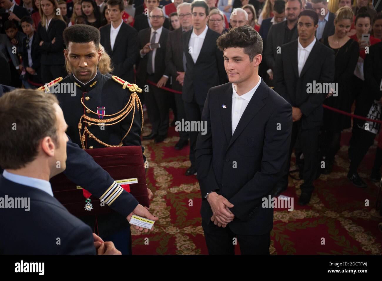 French President Emmanuel Macron receives during an award ceremony ...